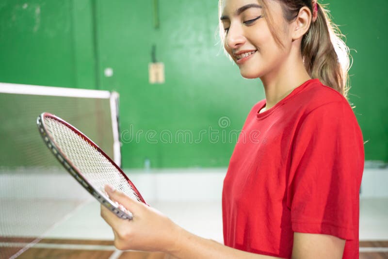 Female Badminton Player Holding Racket Strings To Check Condition Stock ...