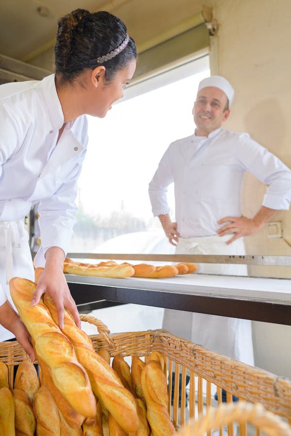 Female Baker Loading Bread into Basket Stock Image - Image of ...
