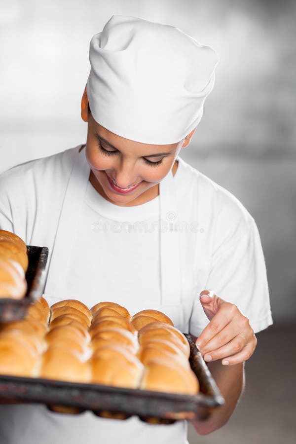Female Baker Looking at Freshly Baked Breads Stock Photo - Image of ...