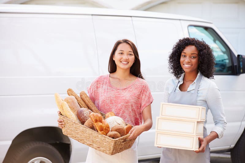 Female Bakers with Bread and Cakes Standing in Front of Van Stock Image ...