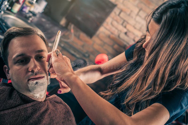 Female Barber Shaving a Client Stock Image - Image of knife, barbershop ...