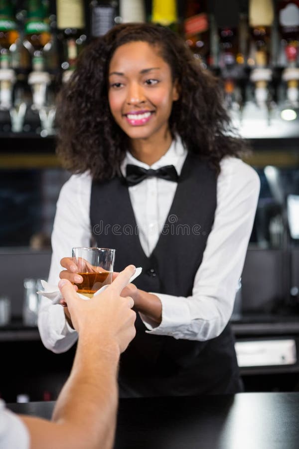 Female Barmaid Serving a Glass of Whiskey Stock Photo - Image of female ...