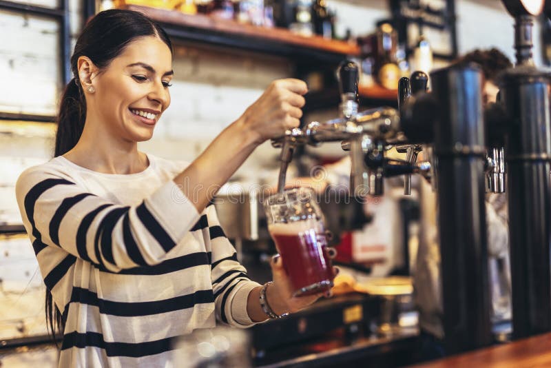 Female Bartender Tapping Beer in Bar Stock Photo - Image of positive ...