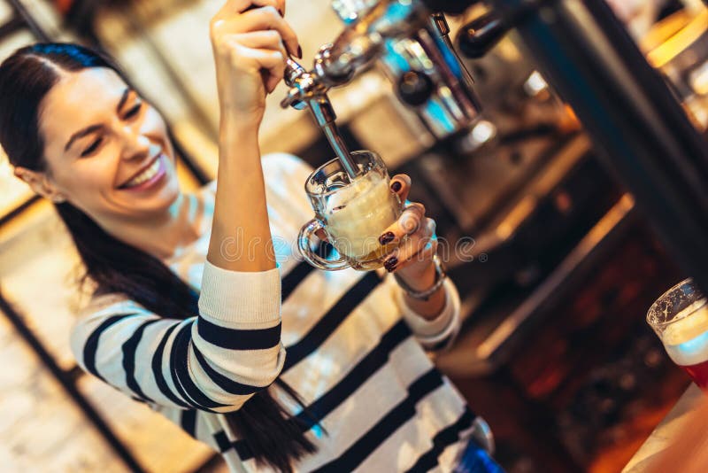 Female Bartender Tapping Beer in Bar Stock Photo - Image of female ...