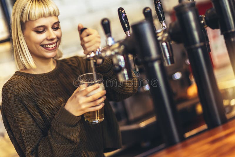 Female Bartender Tapping Beer in Bar Stock Image - Image of alcoholic ...