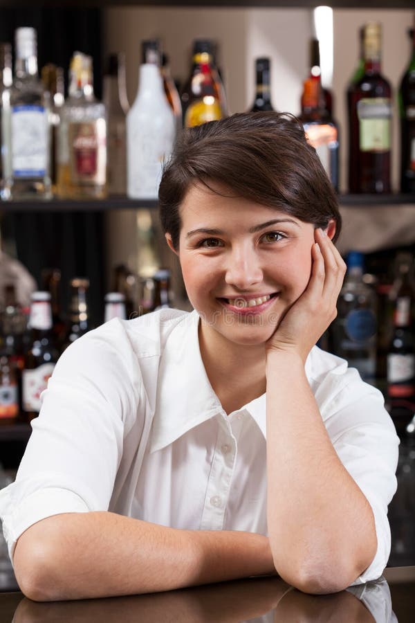 Female Bartender Accurate Pours Drink into Glass Which Standing on ...