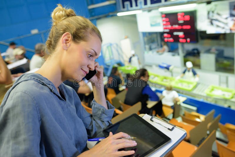 Female Bidder Using Tablet in Auction Hall Stock Photo - Image of ...