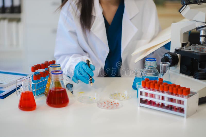Female Biotechnologist Testing New Chemical Substances in a Laboratory ...