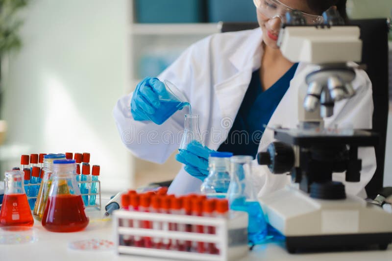 Female Biotechnologist Testing New Chemical Substances in a Laboratory ...