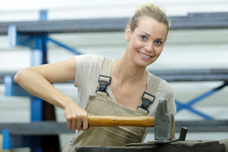 Female Blacksmith Smiling Holding Hammer Stock Photo - Image of wood ...