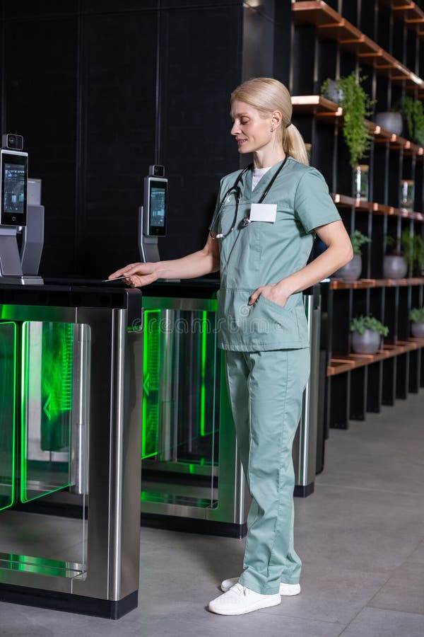 Female Blonde Doctor Passing Security Using Access Card Stock Photos ...