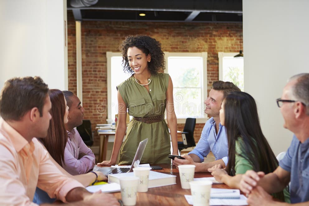 Female Boss Addressing Office Workers at Meeting Stock Photo - Image of ...