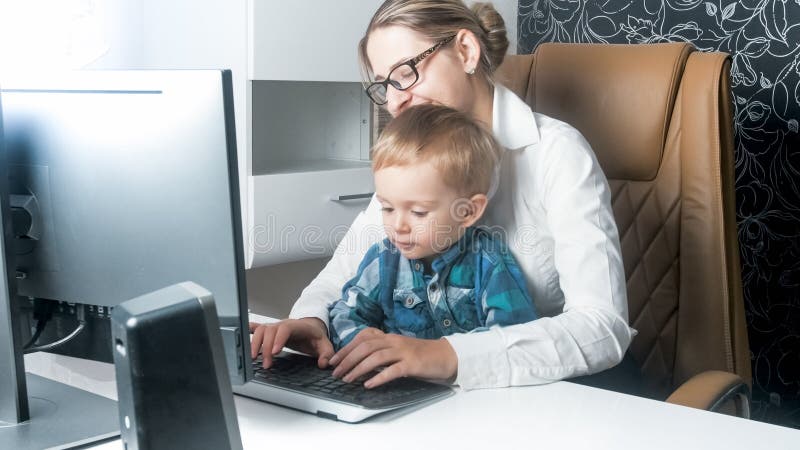 Beautiful Female Boss Working on Computer with Her Toddler Son in ...
