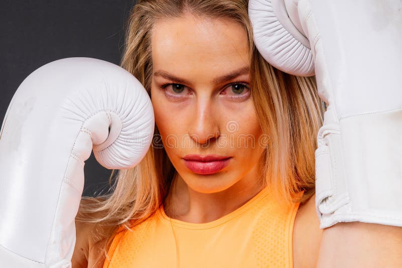 Female Boxer Hitting at a Boxing Studio. Woman in Gloves Training Hard ...
