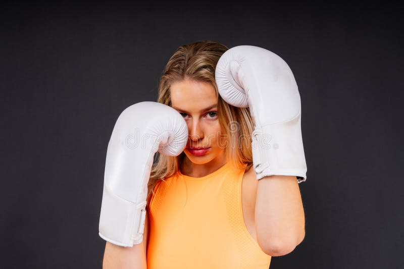 Female Boxer Hitting at a Boxing Studio. Woman in Gloves Training Hard ...