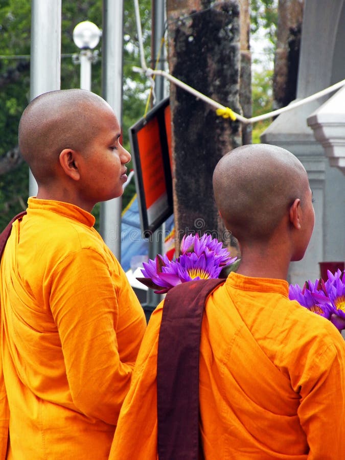 Female Buddhist Sitting on Bed in the Bedroom and Doing Meditation in ...