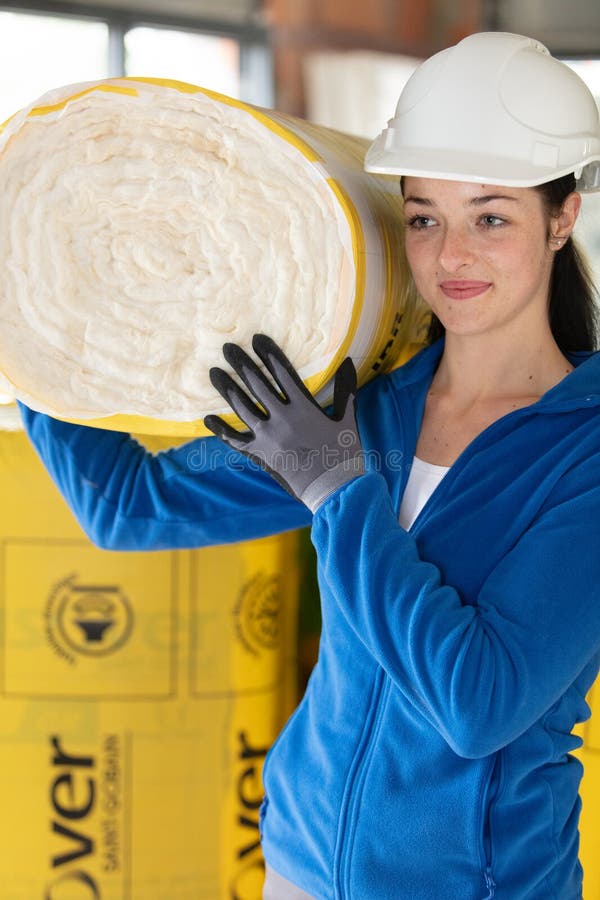 Female Builder Carrying Insulation Roll Stock Image - Image of floor ...