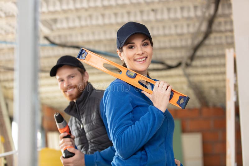 Female Builder Smiling on Construction Site Stock Photo - Image of ...