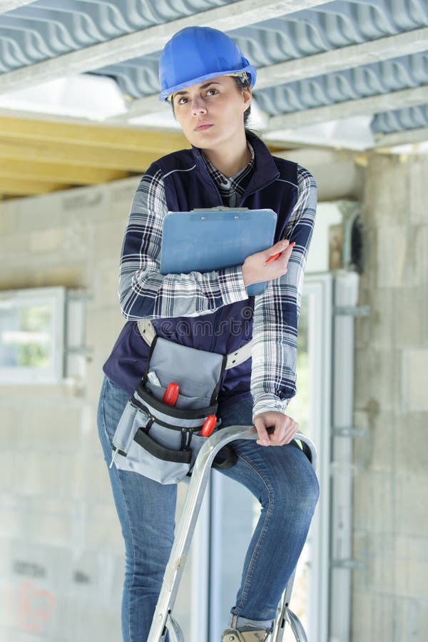 Female Builder Thinking with Clipboard Stock Photo - Image of clipboard ...