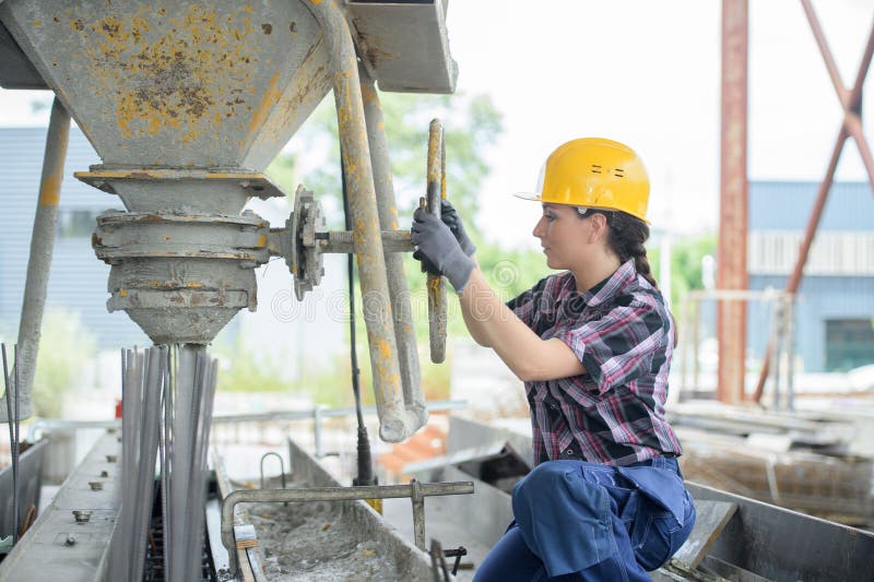 Female Builder Using Cement Mixer on Building Site Stock Photo - Image ...