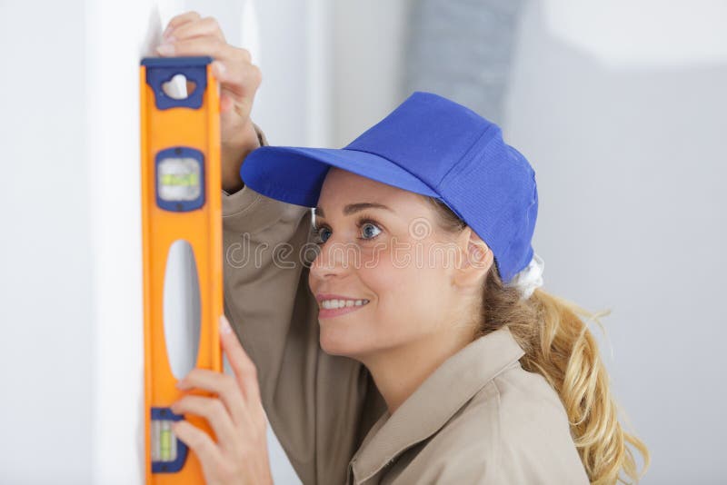 Female Builder Using Spirit Level Stock Image - Image of house, female ...