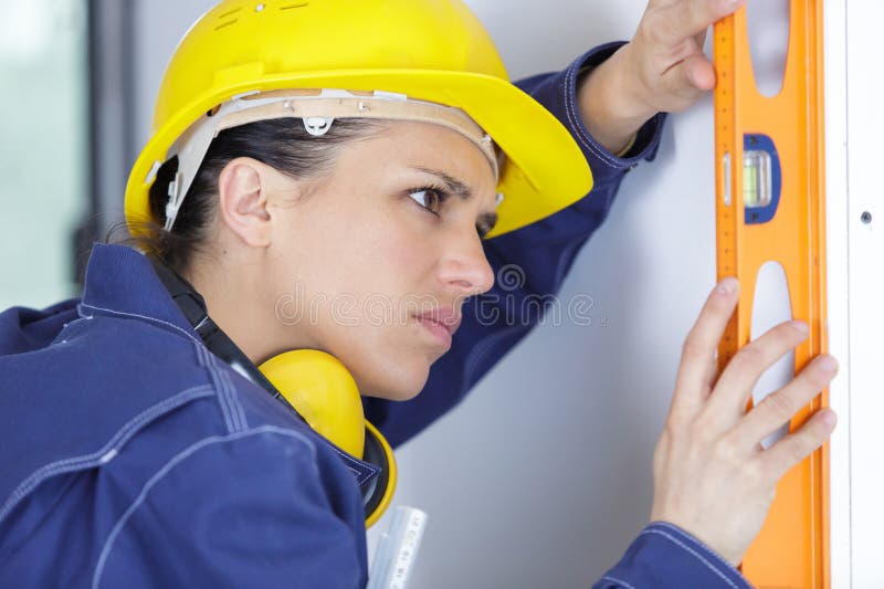 Female Builder Using Spirit Level Stock Image - Image of checking ...