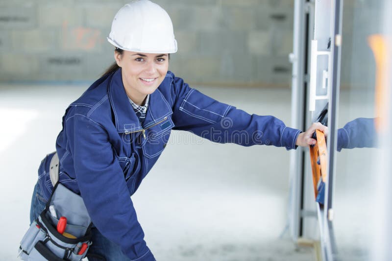 Female Builder Using Spirit Level Stock Photo - Image of architecture ...