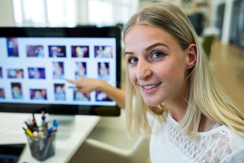 Female Business Executive Pointing at Computer Screen Stock Image ...