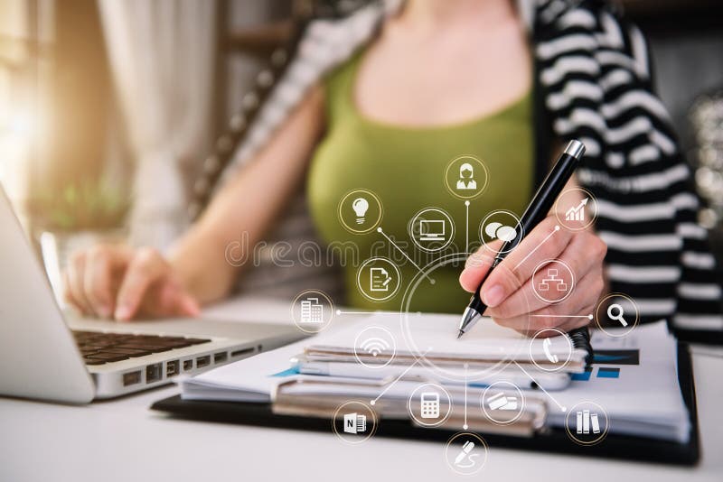 Female Businessman Use a Laptop Computer and Take Notes in the Notebook ...
