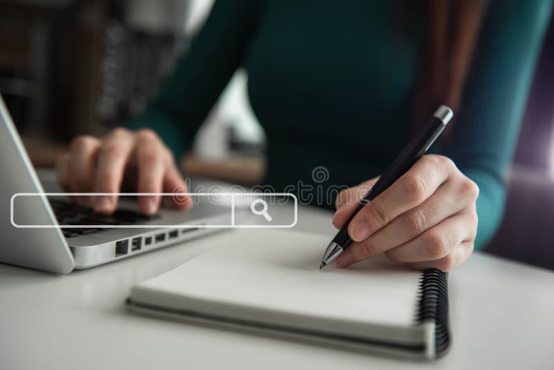 Female Businessman Use a Laptop Computer and Take Notes in the Notebook ...