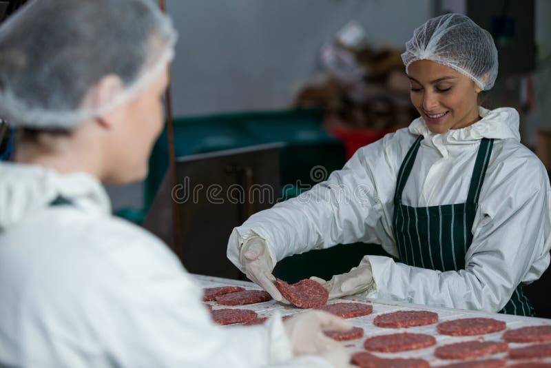 Female Butchers Processing Hamburger Patty Stock Photo - Image of adult ...