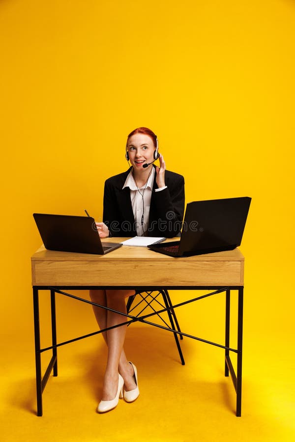 Female Call Center Representative in Suit, Using Headset, Working at ...