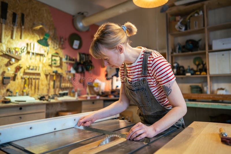 Woman Carpenter Inspecting Wooden Beam Straightness with Ruler before ...