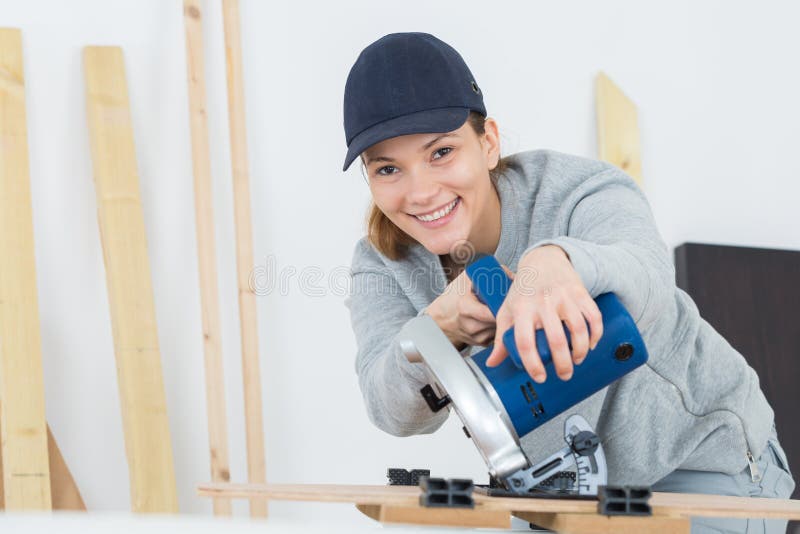 Female Carpenter Cutting Plank Wood Stock Photo - Image of professional ...