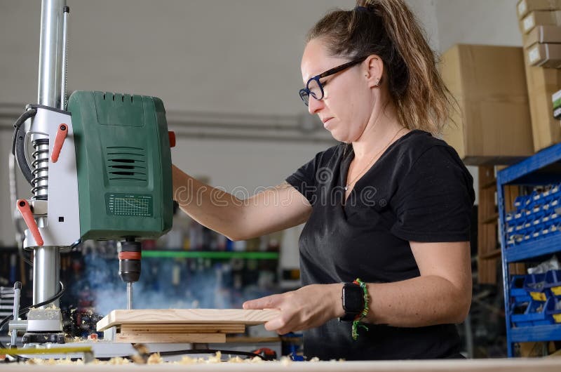 Female Carpenter Drilling Wood in Her Workshop Stock Image - Image of ...