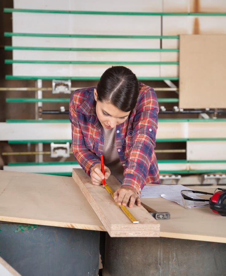 Female Carpenter Measuring Wood with Scale Stock Image - Image of ...