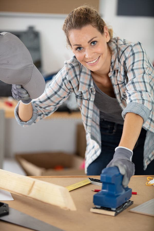 Female Carpenter Using Electric Sander for Wood Stock Photo - Image of ...