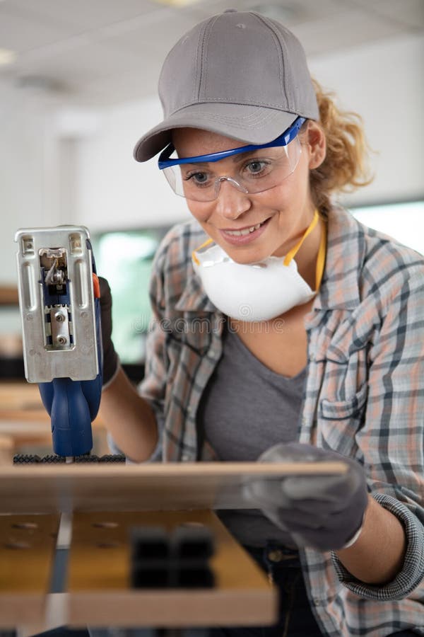Female Carpenter Using Electric Sander for Wood Stock Image - Image of ...