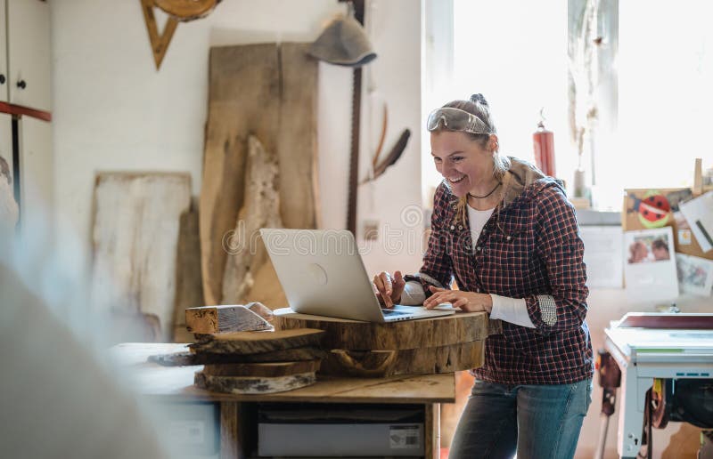 Female Carpenter Using Laptop in a Carpentry Workshop Stock Image ...