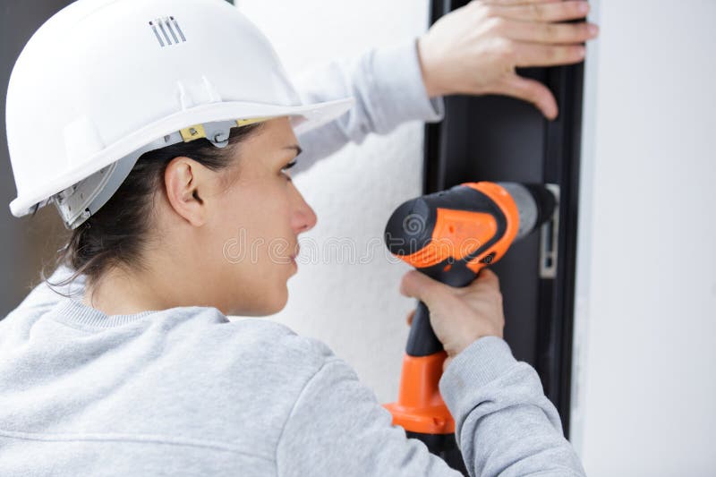 Female Carpenter at Work Using Hand Drilling Machine Stock Photo ...