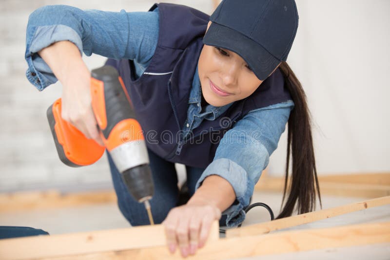 Female Carpenter at Work Using Hand Drilling Machine Stock Photo ...