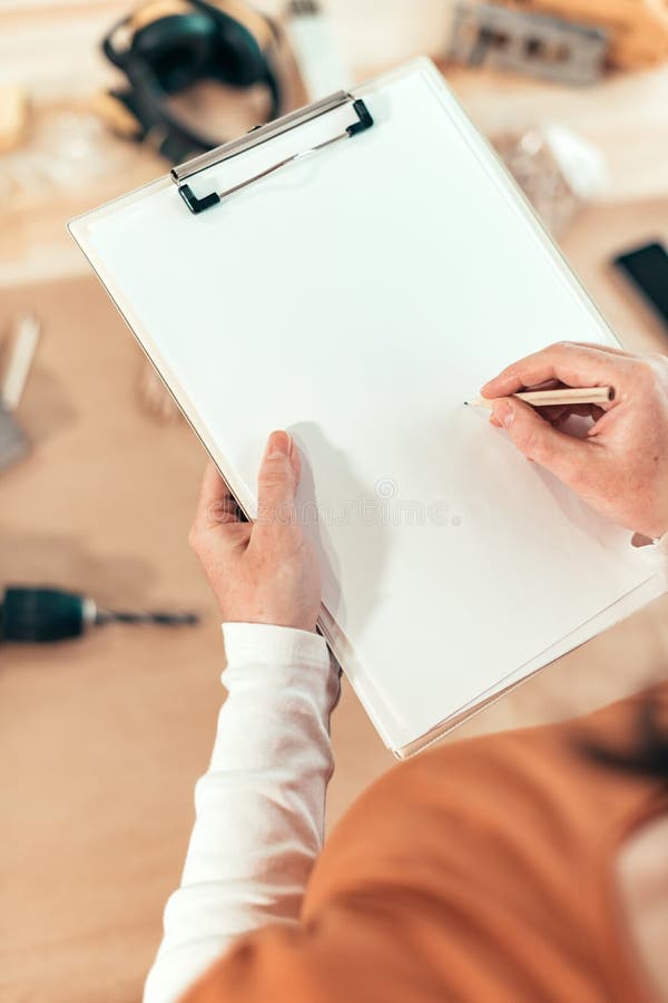 Female Carpenter Writing DIY Project Notes Stock Photo - Image of ...