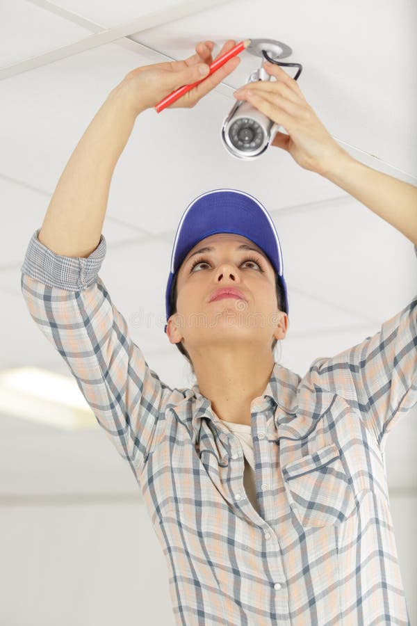 Female Cctv Installer Installing Security Camera Stock Image - Image of ...