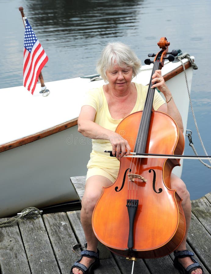 Female cellist. stock image. Image of river, cello, senior - 21838259