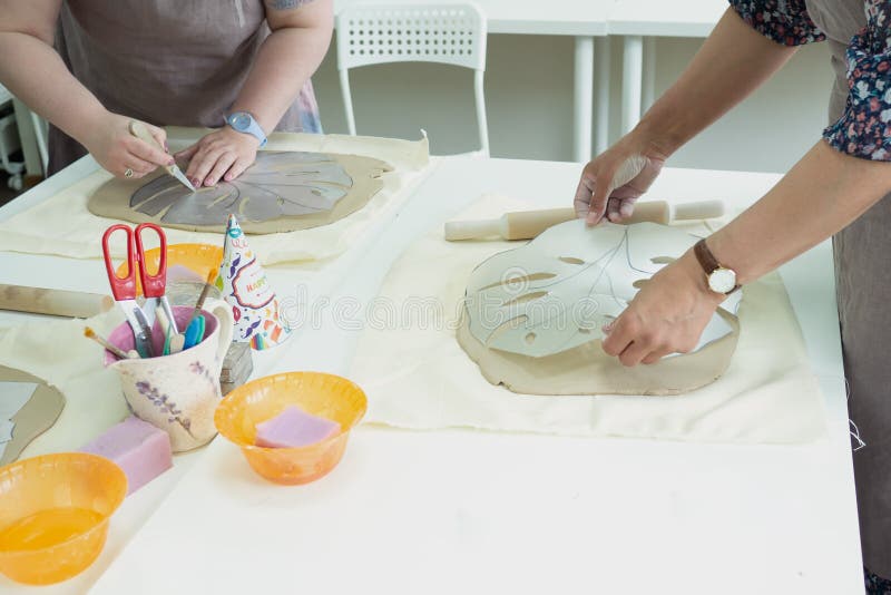 Female Ceramist Rolls Clay Using Wooden Rolling Pin in Ceramic Studio ...
