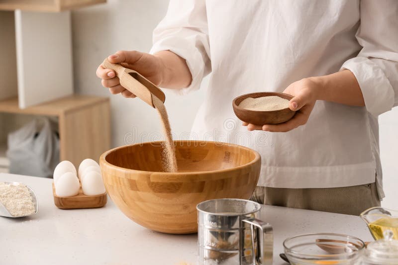 Female Chef Adding Dry Yeast in Bowl on Kitchen Table, Closeup Stock ...
