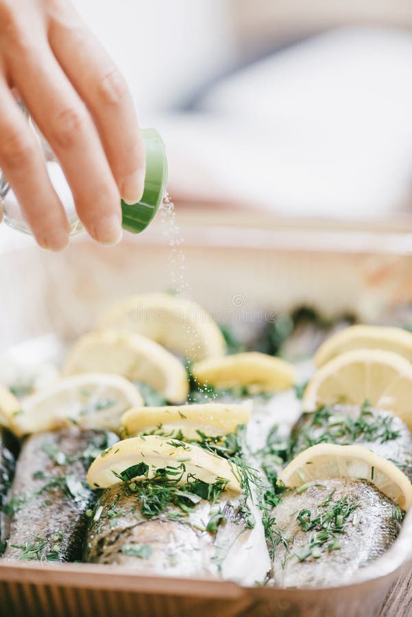Female Chef Adding Salt To Fish Dish. Stock Image - Image of greenery ...