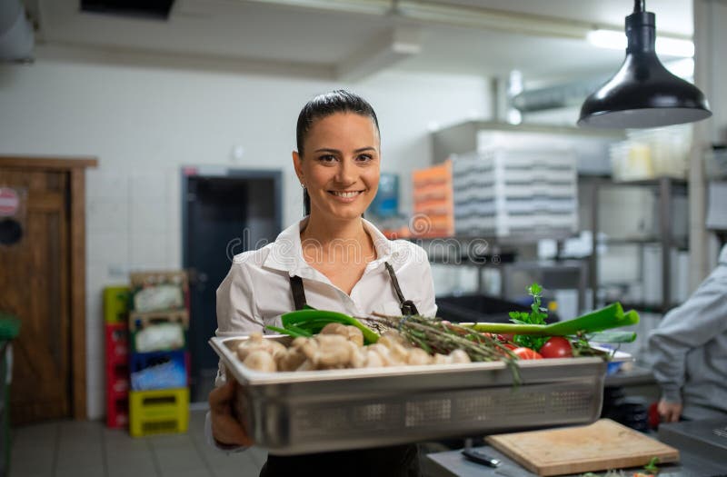 Female Chef Carrying Tray with Fresh Vegetables and Looking at Camera ...