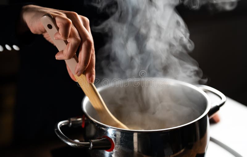 Female Chef Cooking with Steam Stock Image - Image of cuisine, metallic ...