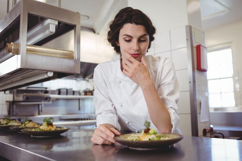 Female Chef Examining Appetizer Plate at Order Station Stock Photo ...